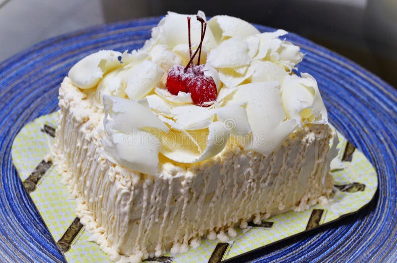A Small White Chocolate Cake with Cherries with Icing Sugar Decorating ...