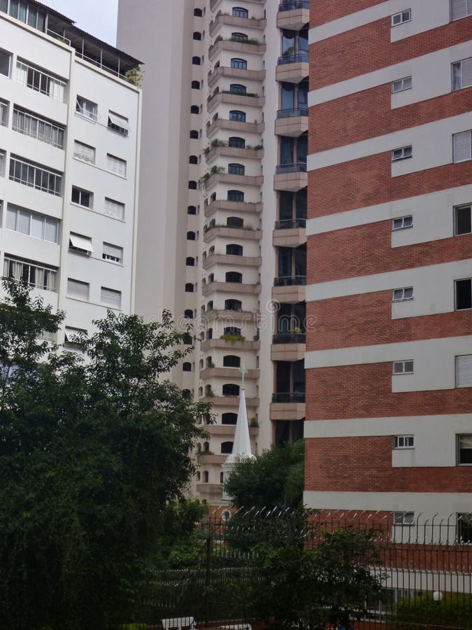 Small White Church Tower between High Modern Buildings Stock Image ...
