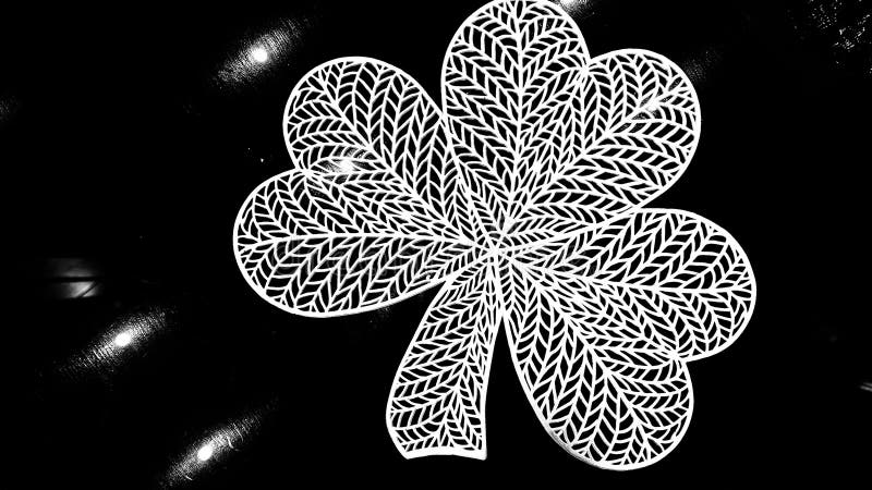 A Small White Cloverleaf-shaped Tablecloth Placed on a Black Marble ...