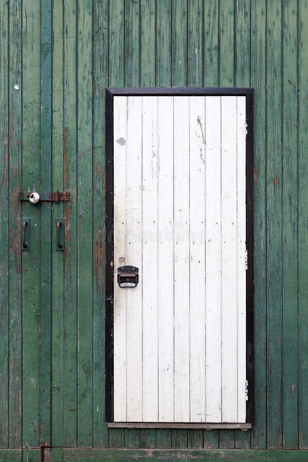 Small White Door in Large Green Barn Door Stock Photo - Image of broken ...
