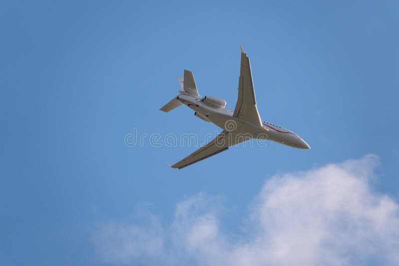 Small White Jet Airplane Flies in the Blue almost Cloudless Sky Stock ...