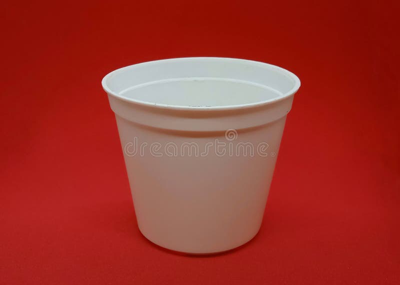 Small White Plastic Pot, Isolated on the Red Background. Stock Photo ...