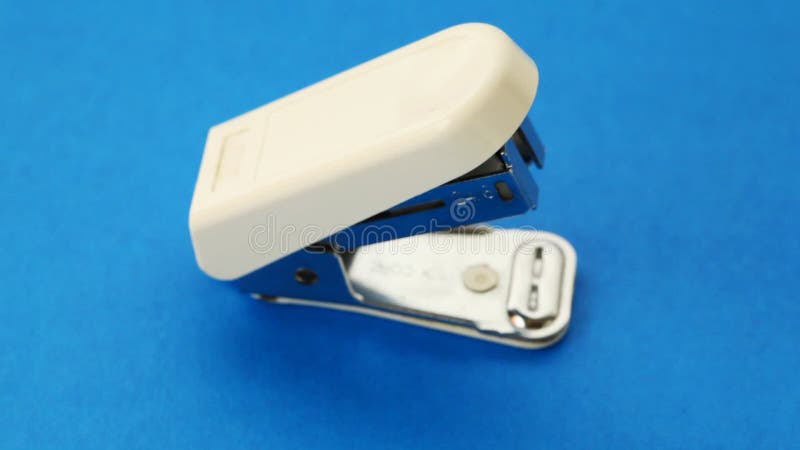 Small White Stapler Rotates Alone on Dark Blue Stock Footage - Video of ...