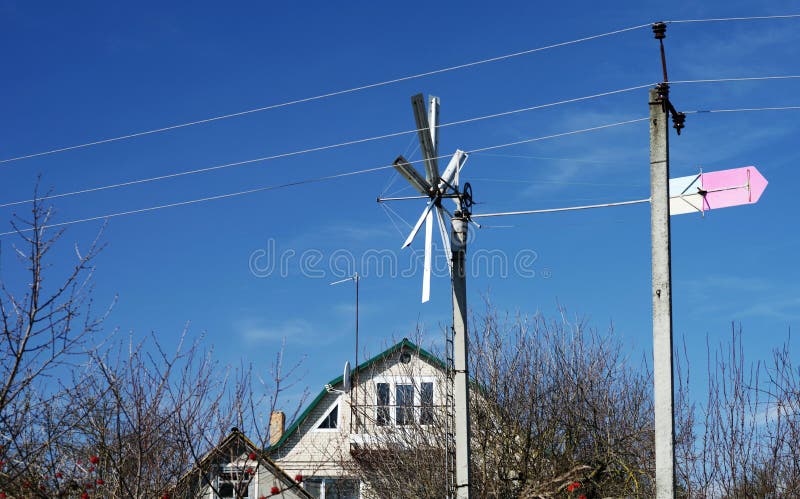 A Small Wind Generator in the Yard Near the House Stock Photo - Image ...