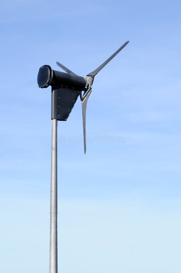 Small Wind Turbine in Front of an Electricity Pylon Stock Image - Image ...