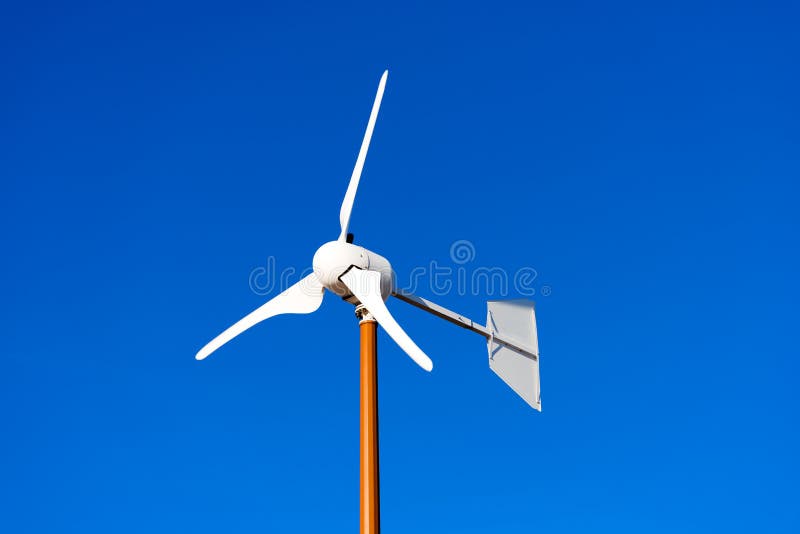 Small Wind Turbine in Front of an Electricity Pylon Stock Image - Image ...