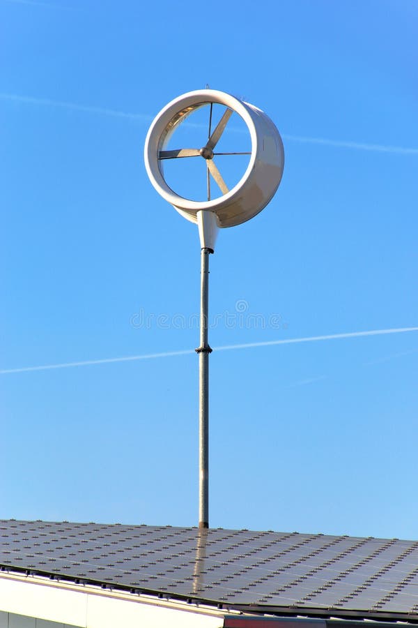 Small Wind Turbine in Front of an Electricity Pylon Stock Image - Image ...