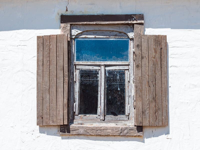 A Small Window with Dilapidated Wooden Shutters in an Old Hut Stock ...