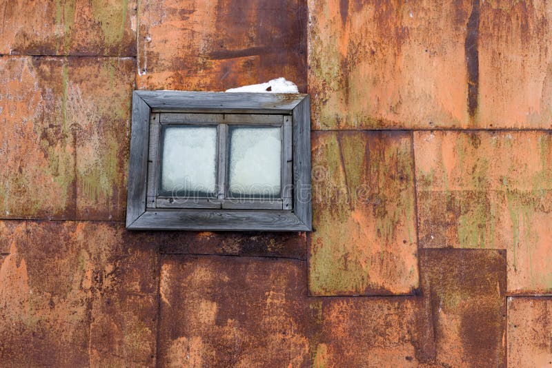 Small Window in a Metal Wall. Weathered Rough Surface of Rusty Metal ...