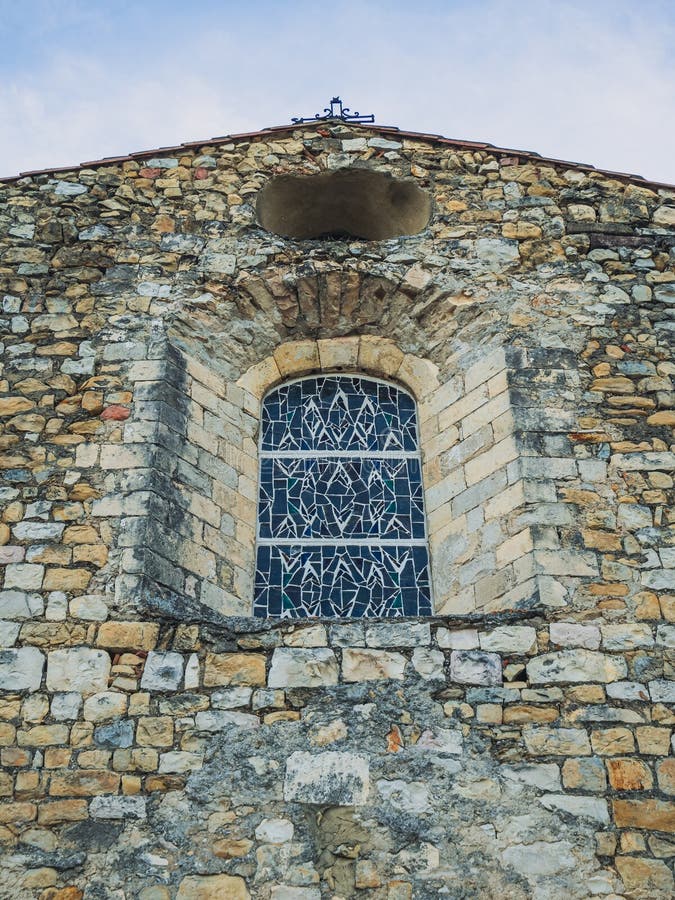 A Small Window with a Stained Glass Window in an Old Stone Church Stock ...