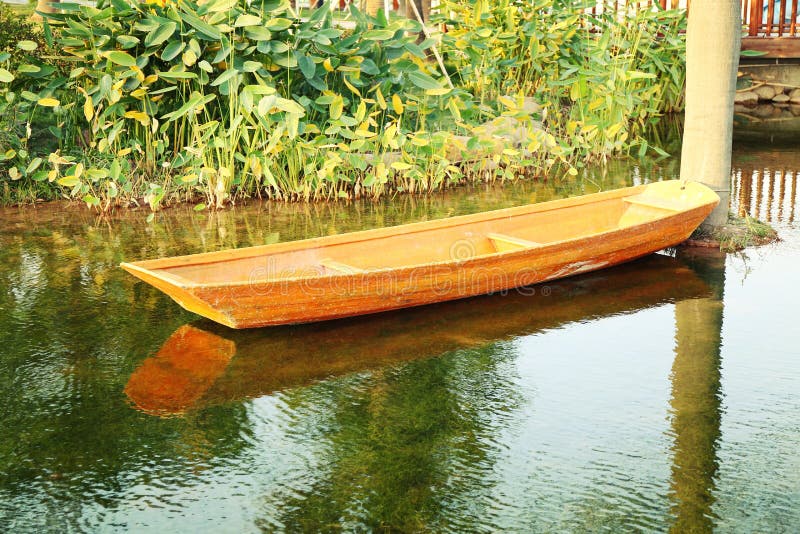 Small Wooden Boat on Garden Pond Stock Photo - Image of landscaping ...