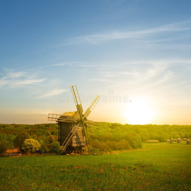 Small Wooden Windmill among Green Rural Fields at the Sunset Stock ...