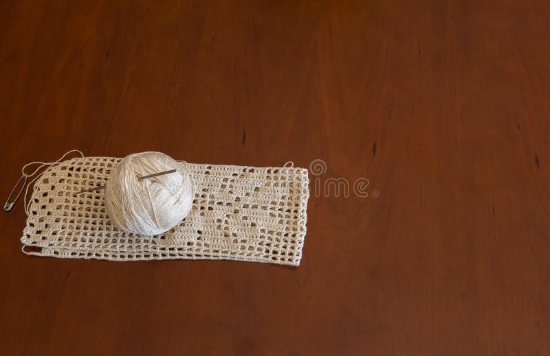 Small Work of Crochet and Crochet Ball on Wooden Table with Copy Space ...