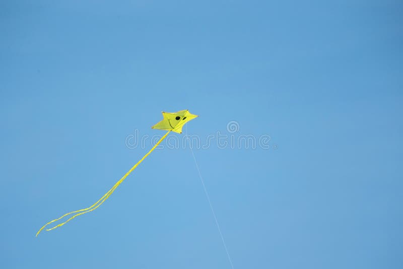 Small Yellow Kite Flying in the Blue Sky Stock Photo - Image of launch ...
