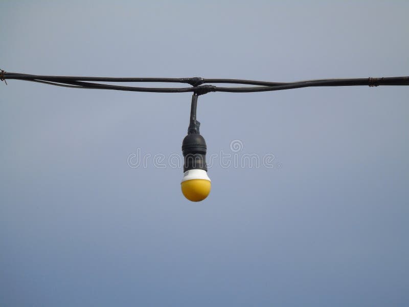 A small, yellow light bulb stock photo. Image of bulb - 200300612