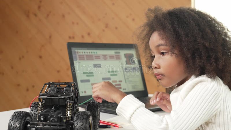 African Girl Build Robotic Car while Using Wires while Using Laptop ...