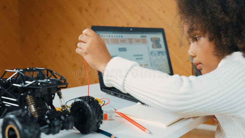 African Girl Build Robotic Car while Using Wires while Using Laptop ...