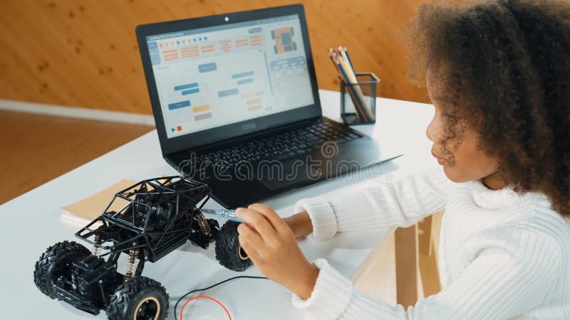 African Girl Build Robotic Car while Using Wires while Using Laptop ...