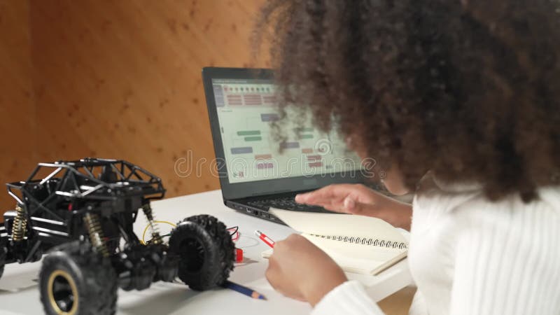 African Girl Build Robotic Car while Using Wires while Using Laptop ...