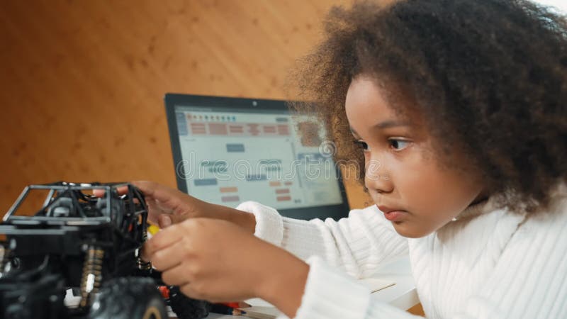 African Girl Build Robotic Car while Using Wires while Using Laptop ...