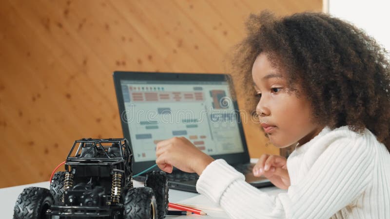 African Girl Build Robotic Car while Using Wires while Using Laptop ...