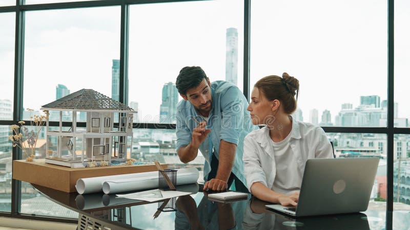 Smart Engineer Inspect House Model while Colleague Using Laptop ...
