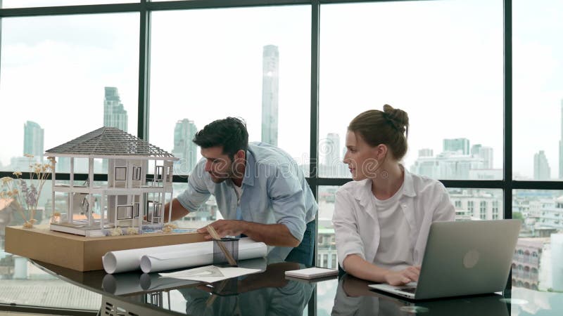Smart Engineer Inspect House Model while Colleague Using Laptop ...