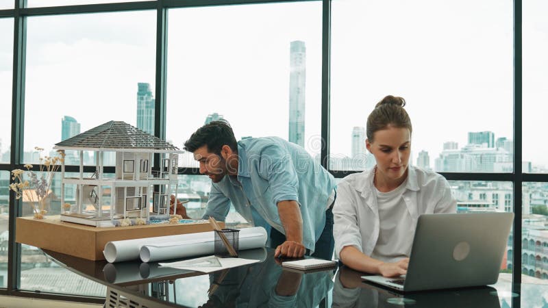 Smart Engineer Inspect House Model while Colleague Using Laptop ...