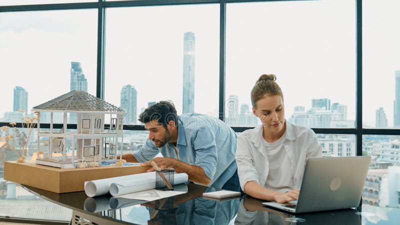 Smart Engineer Inspect House Model while Colleague Using Laptop ...