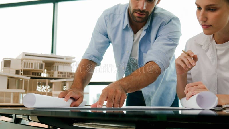 Smart Engineer Inspect House Model while Colleague Using Laptop ...