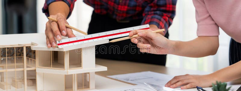 Smart Architect Engineer Working Together and Measuring House Model ...