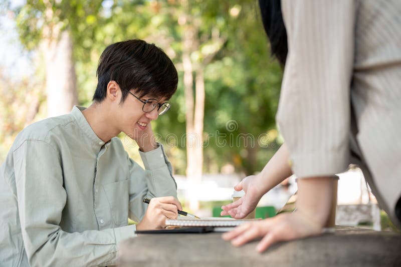 A Smart Asian Male Student is Sharing His Ideas with His Friend while ...