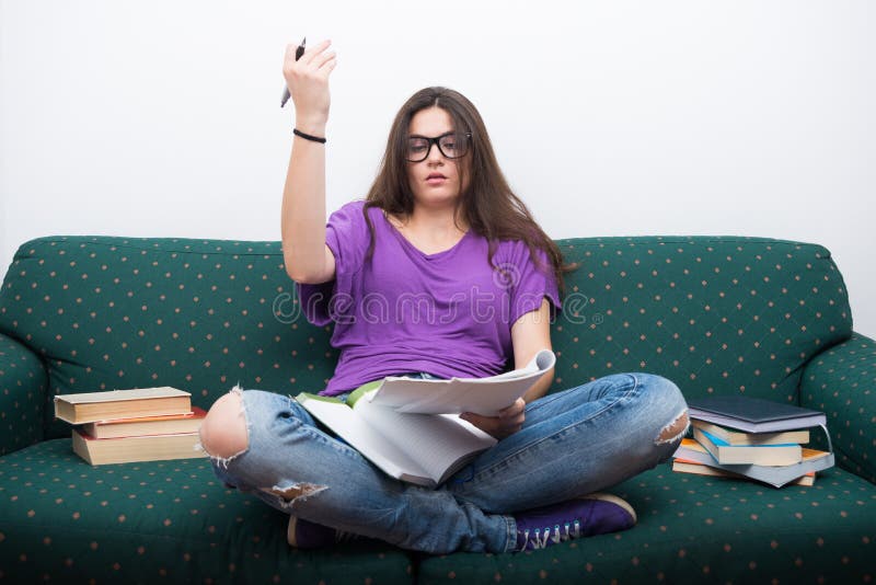 Beautiful Young Woman on a Couch Doing Homework Stock Image - Image of ...