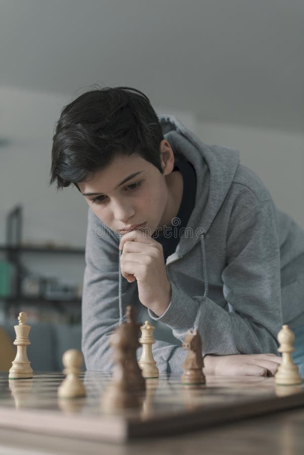 Smart Boy Playing Chess and Staring at the Chessboard Stock Image ...