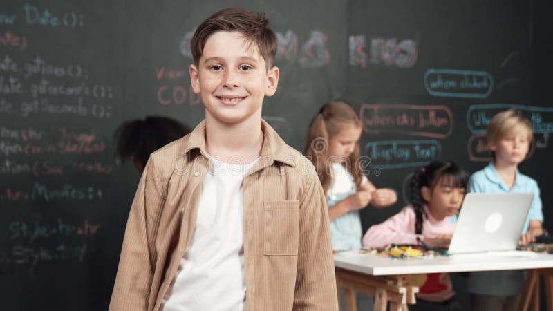 Smart Boy Smiling at Camera while Diverse Friend Working at Board ...