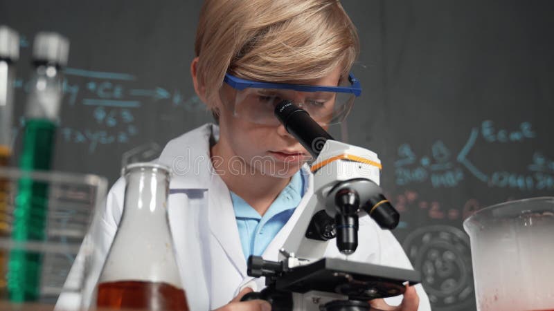 Smart Boy Using Microscope Analysis Sample at Science Laboratory ...