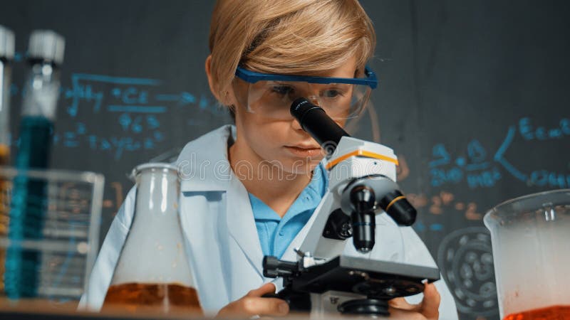Smart Boy Using Microscope Analysis Sample at Science Laboratory ...
