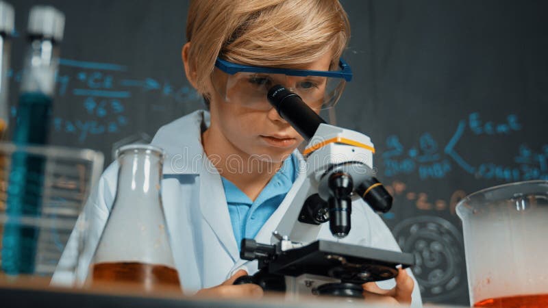 Smart Boy Using Microscope Analysis Sample at Science Laboratory ...