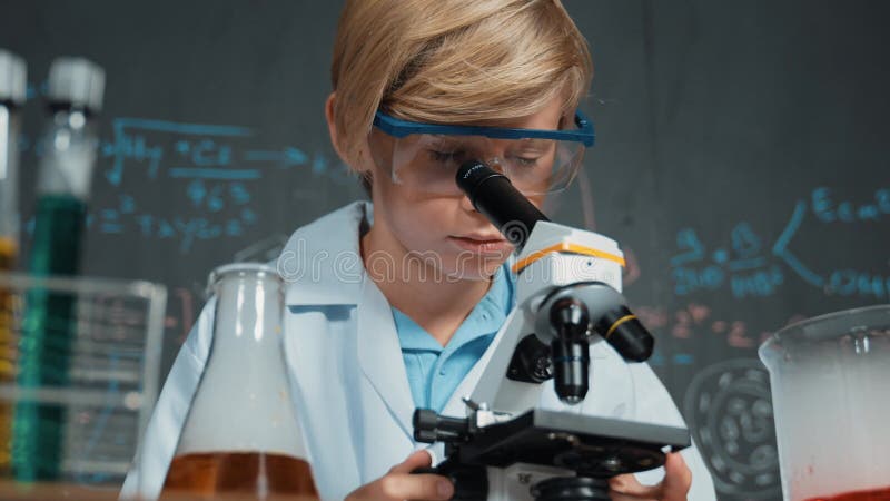 Smart Boy Using Microscope Analysis Sample at Science Laboratory ...