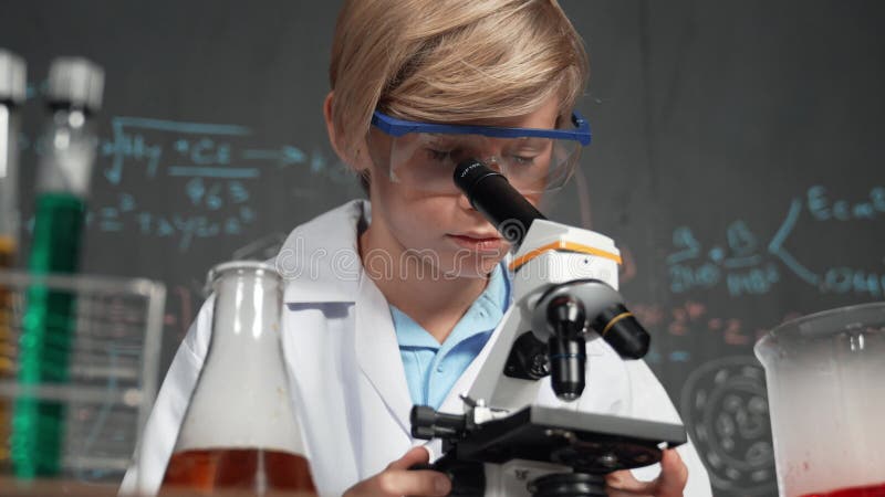 Smart Boy Using Microscope Analysis Sample at Science Laboratory ...