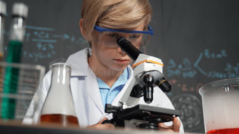 Smart Boy Using Microscope Analysis Sample at Science Laboratory ...
