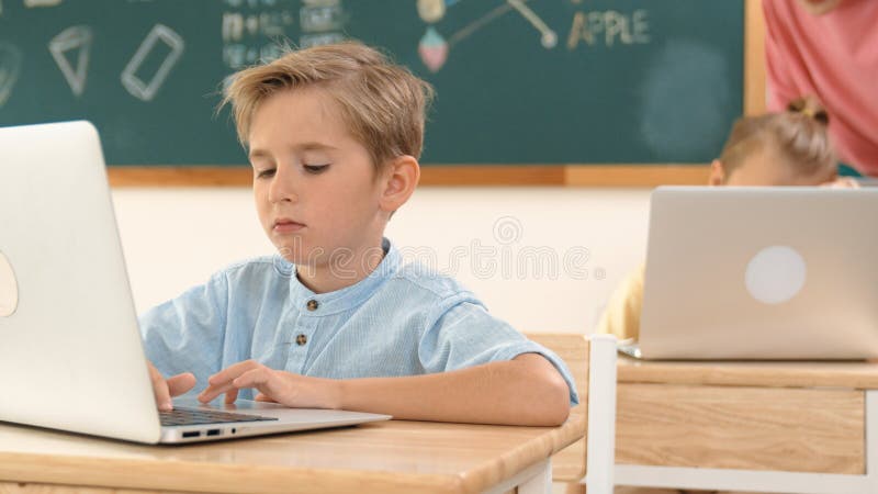 Smart Boy Working at Laptop while Diverse Children Programing System ...