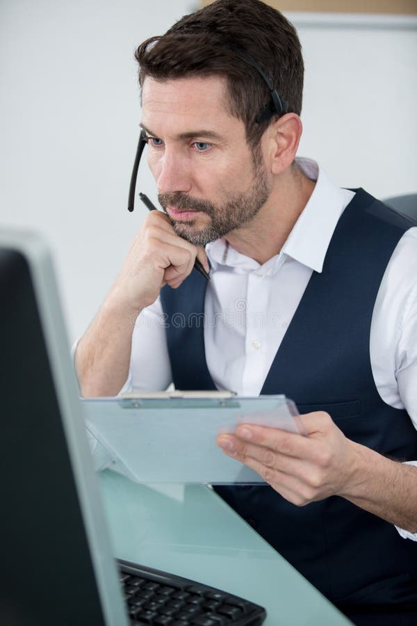 Smart Businessman in White Shirt Verifying Information from Paper Stock ...
