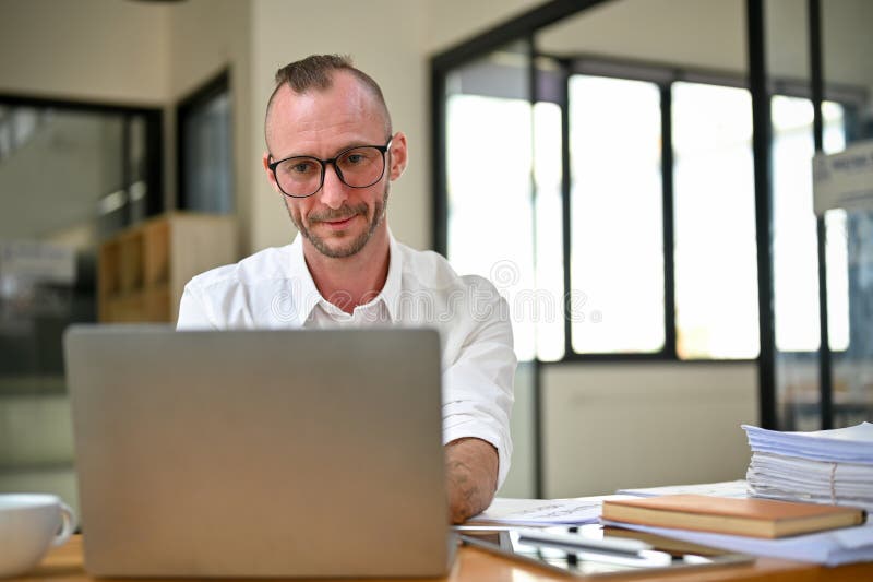 Smart Caucasian Businessman Using Laptop Computer at His Desk, Working ...