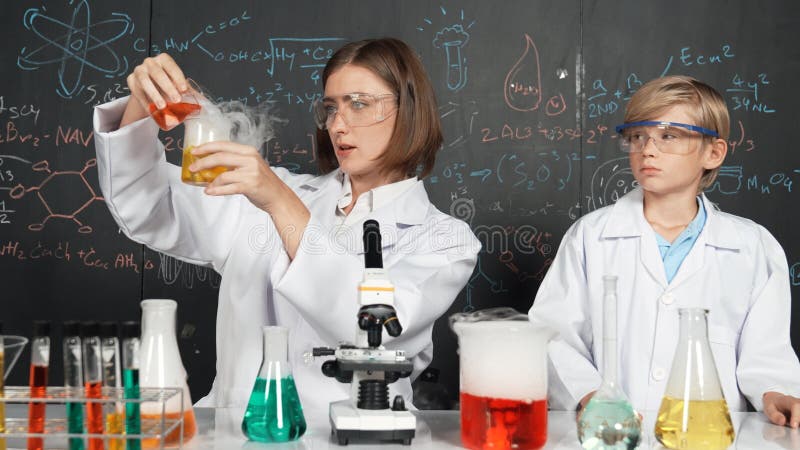 Smart Caucasian Teacher Mixing Chemical Liquid in Science Laboratory ...