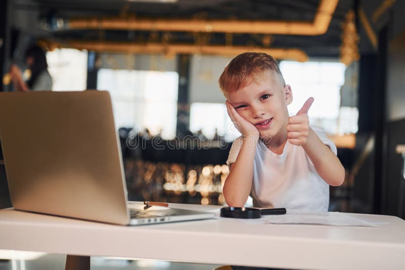 Smart Child in Casual Clothes with Laptop on Table Have Fun Stock Photo ...
