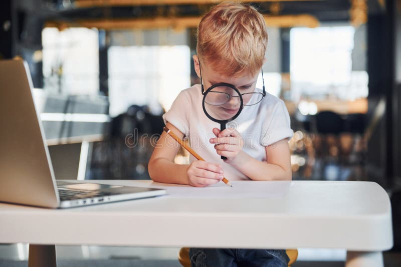Smart Child in Casual Clothes with Laptop on Table Have Fun with ...