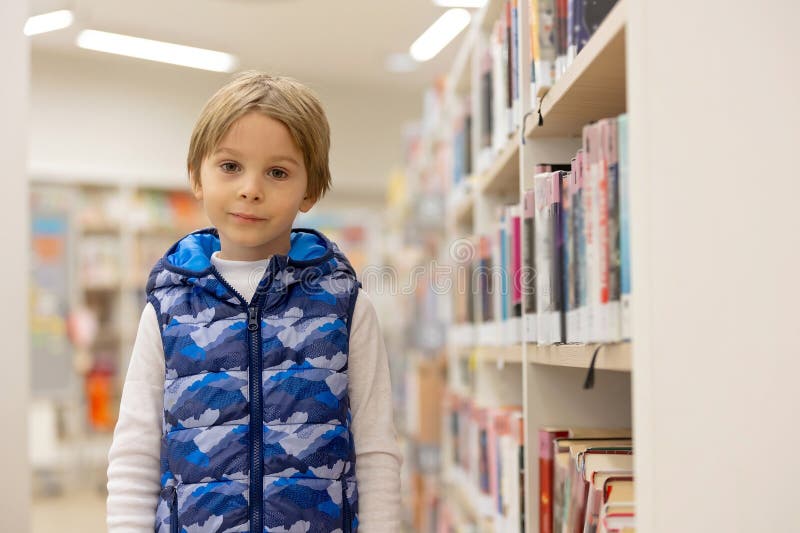 Smart Child, School Boy, Educating Himself in a Library, Borrowing ...
