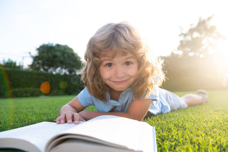 Smart Clever Boy Reading Book on Green Grass. Stock Image - Image of ...