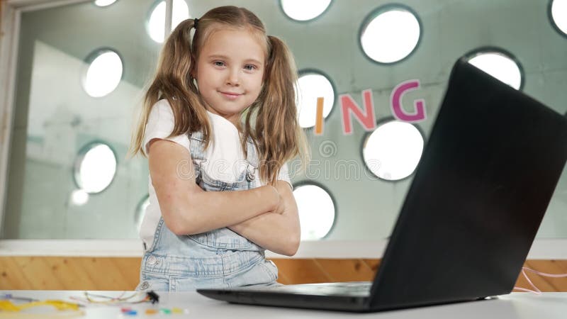 Smart Cute Girl Using Laptop Programing Software while Crossing Arms ...